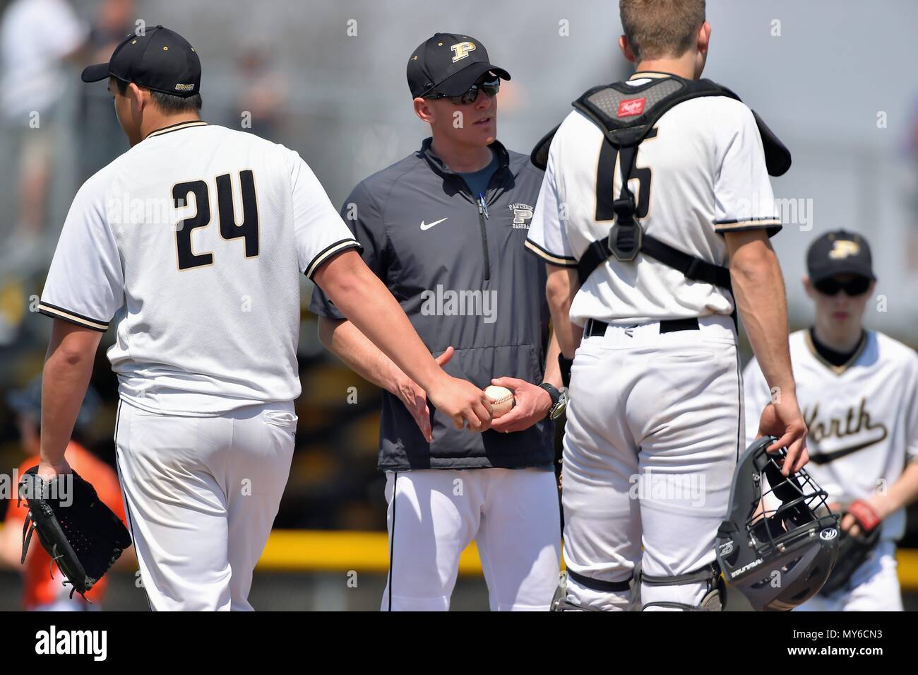 Coach making decision to change pitcher during a trip to the mound. USA ...