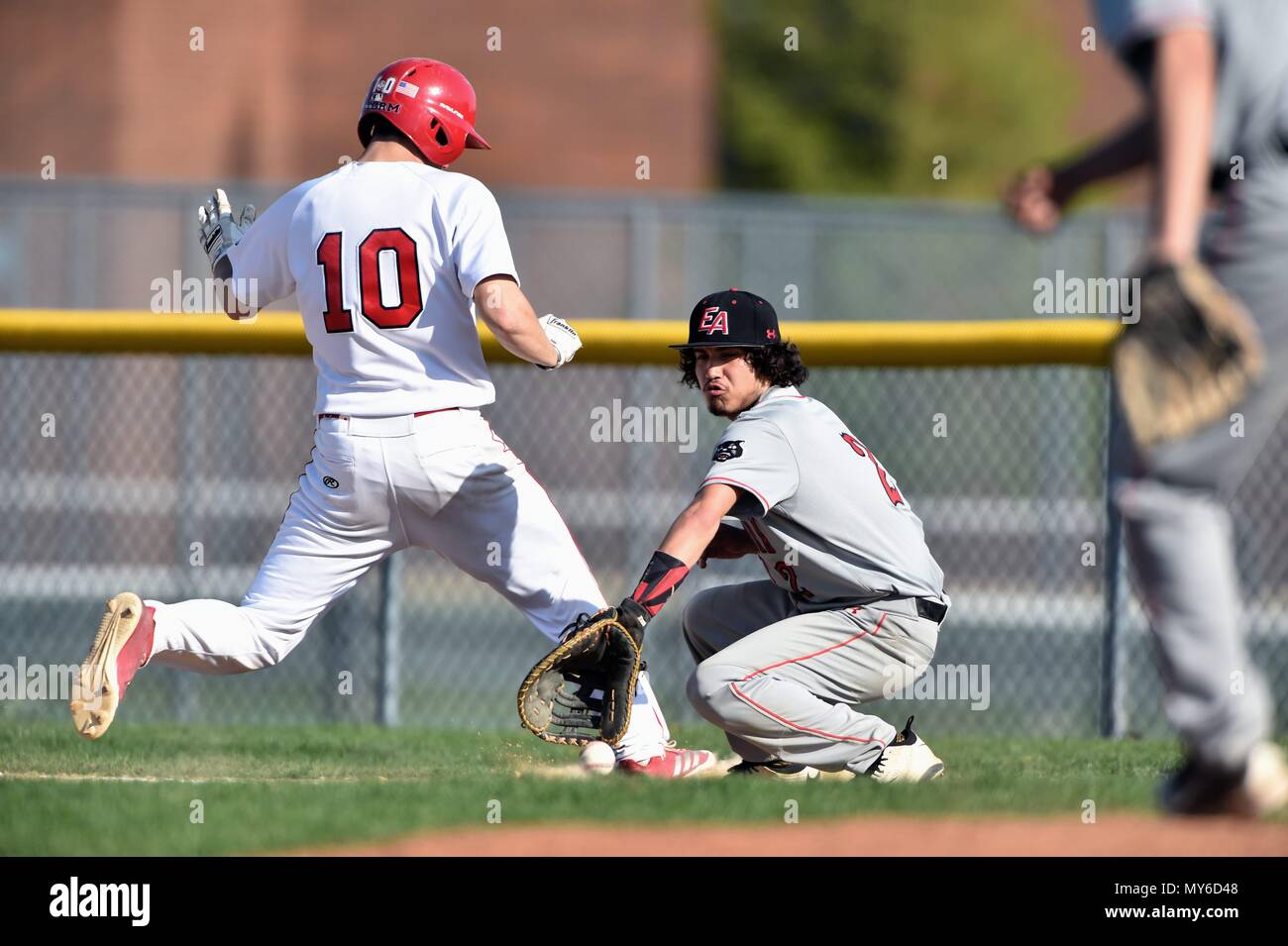 Runner returning back to first base ahead of a pick-off attempt by the ...