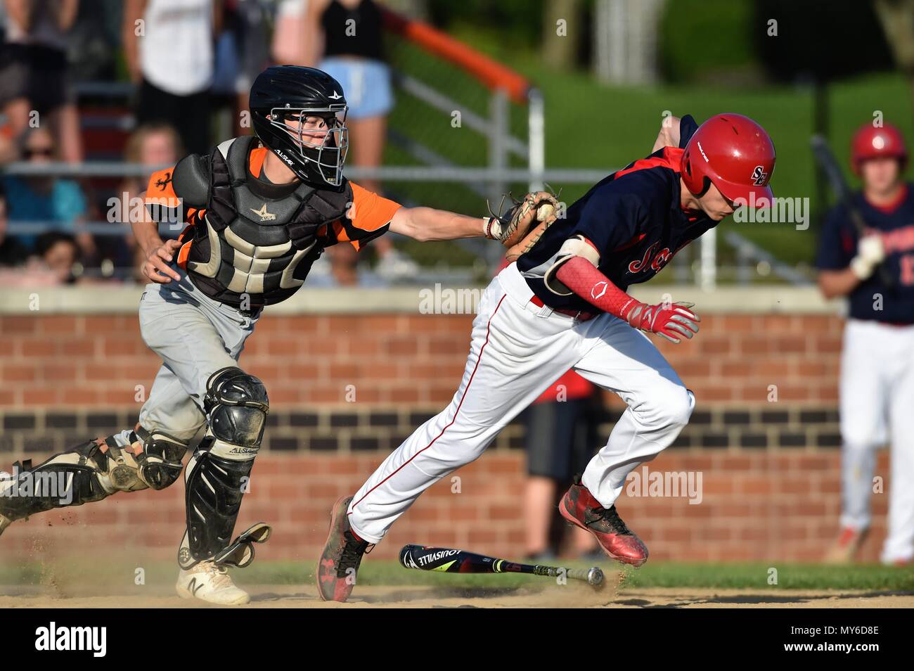 Following a dropped third strike a catcher pursues the batter while ...