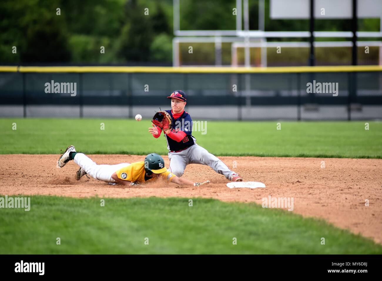 Shortstop taking a pick-off throw in an effort to catch an opposing ...