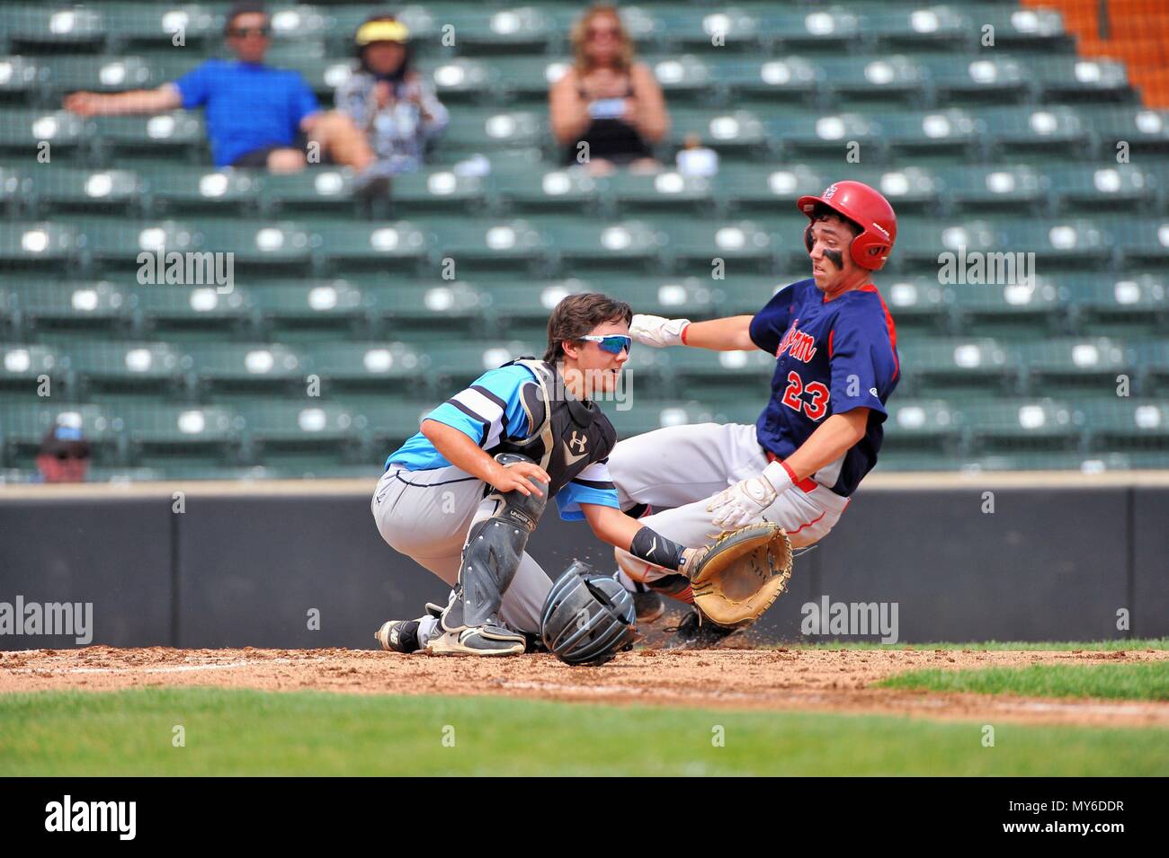 Runner scoring as the opposing catcher awaits a tardy throw from the ...
