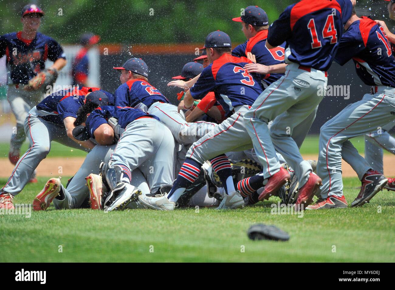 Players rush the pitcher's mound and begin to form a human mound ...