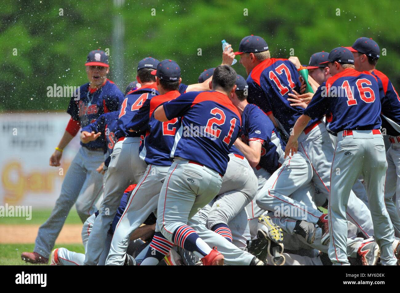 Players rush the pitcher's mound and begin to form a human mound ...