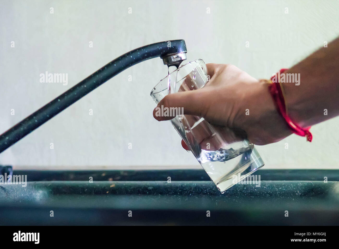 Pouring water from a tap into a glass hi-res stock photography and ...