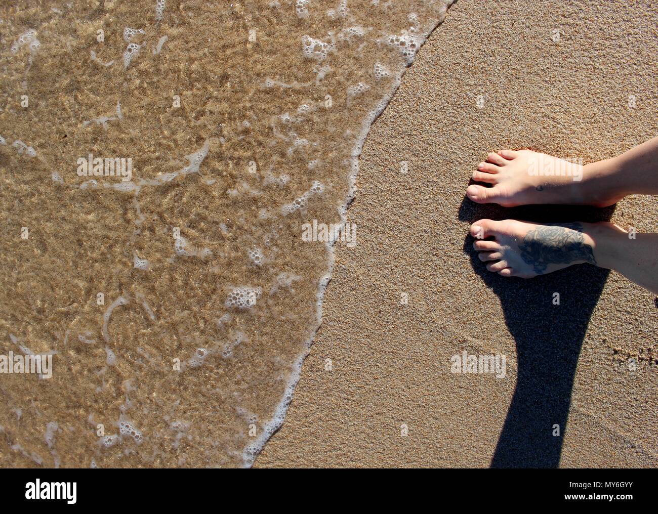 A beachgoer dipping their toes in the Mediterranean Sea Stock Photo - Alamy