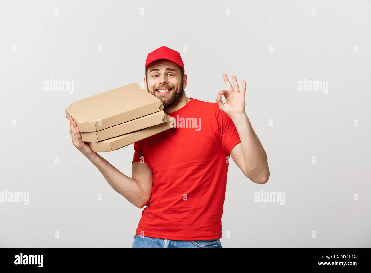 Delivery Concept: Handsome pizza delivery man making OK sign isolated ...