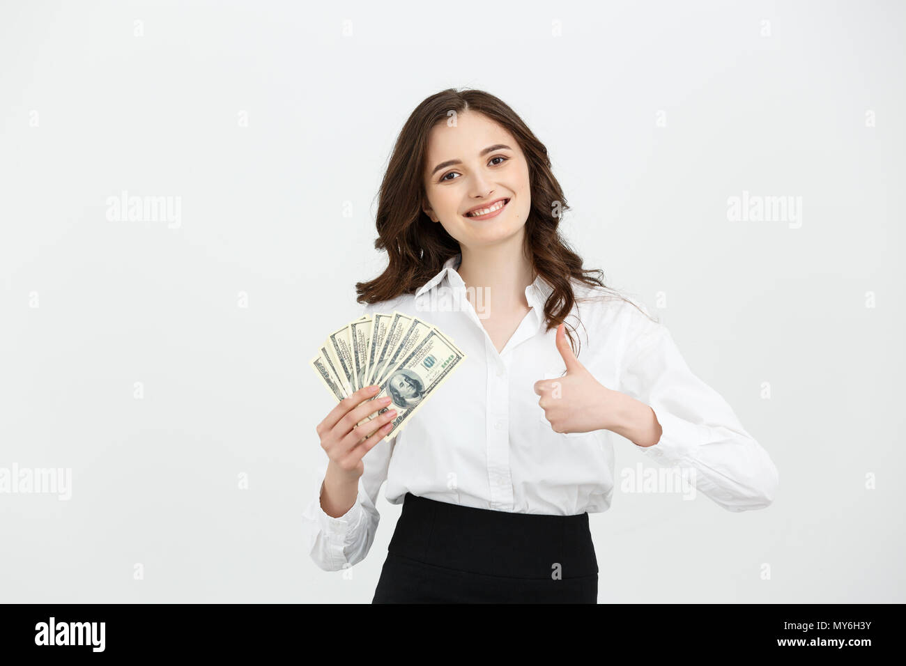 Beautiful young business woman with dollar bills on white background ...