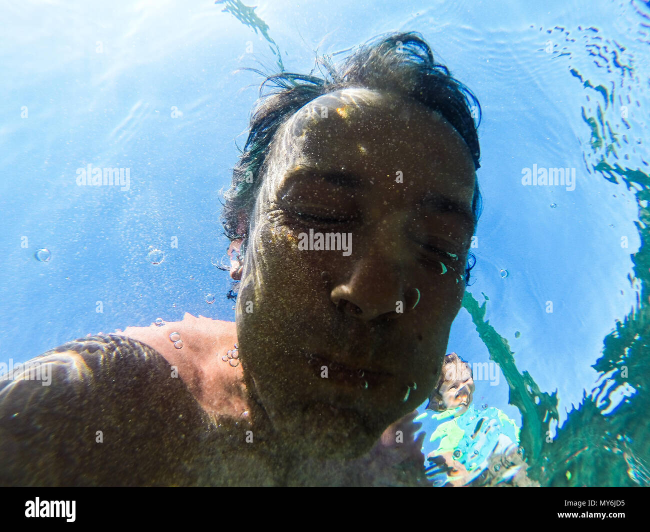 Underwater view of man swimming in the sea Stock Photo - Alamy