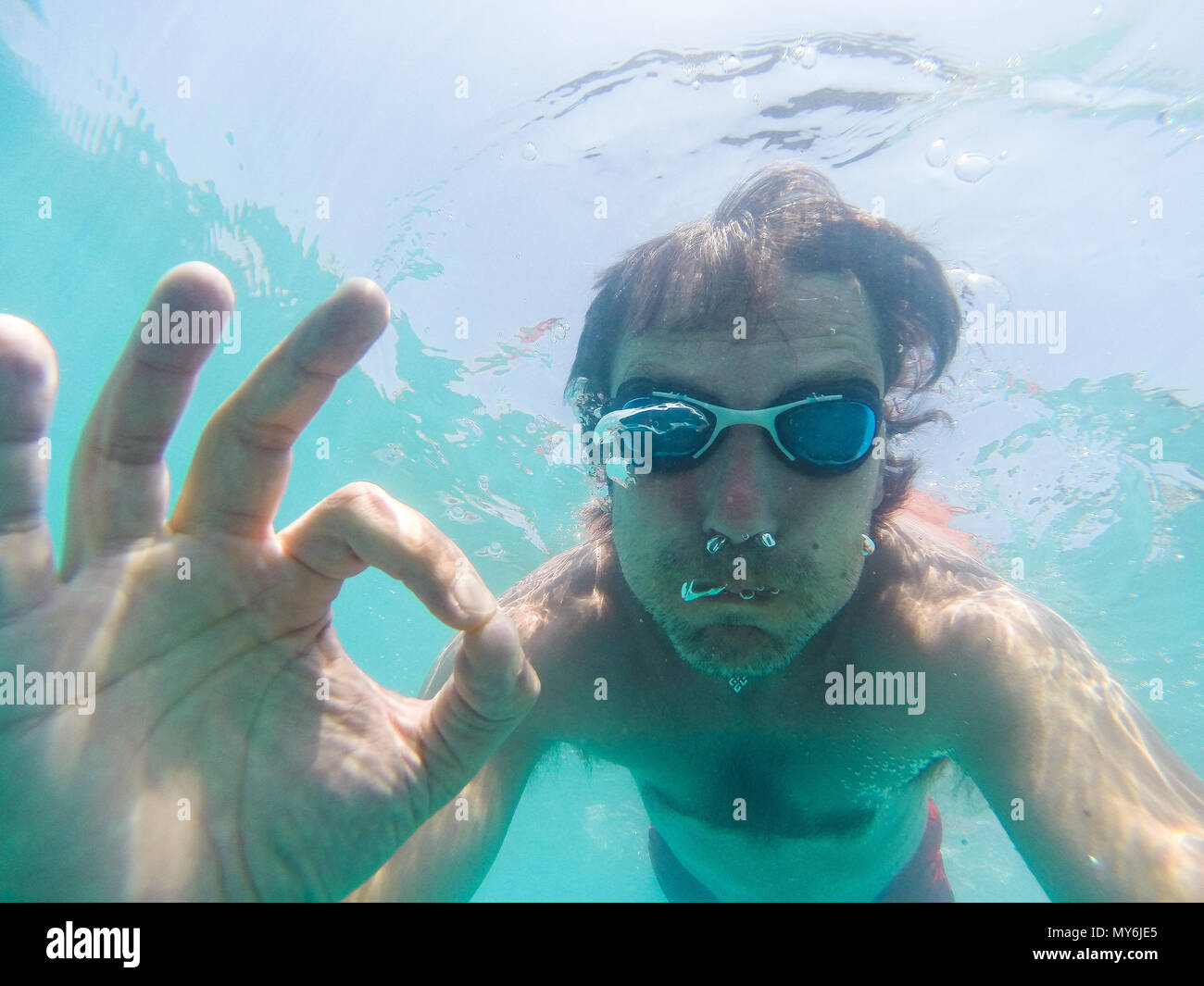 Underwater view of man swimming in the sea Stock Photo - Alamy