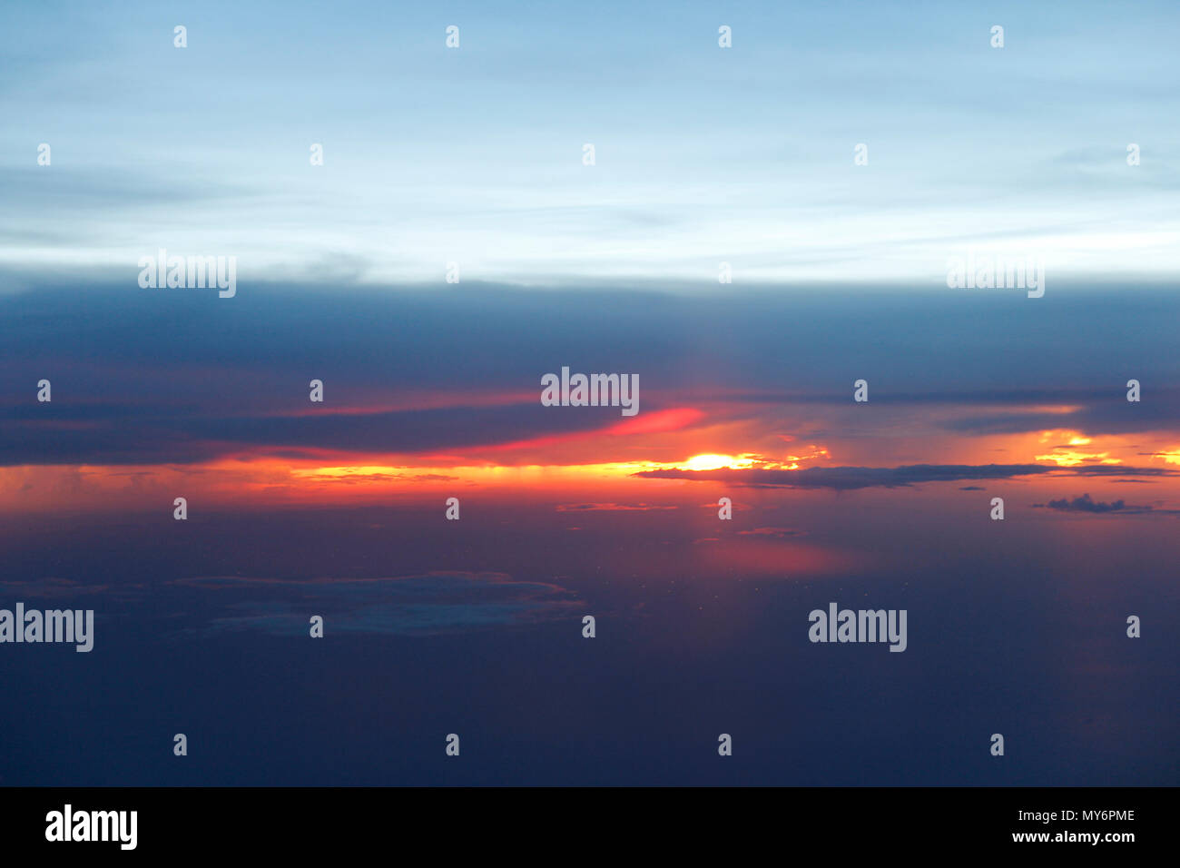 Dramatic cloudscape with the sun during sunset from the airplane's window Stock Photo - Alamy