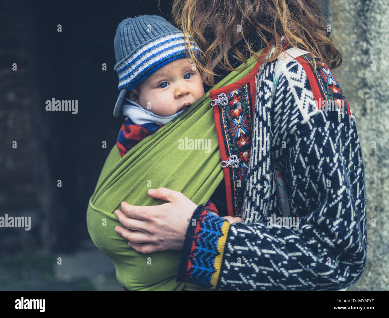 Mother carrying traditional baby carrier hi-res stock photography and ...