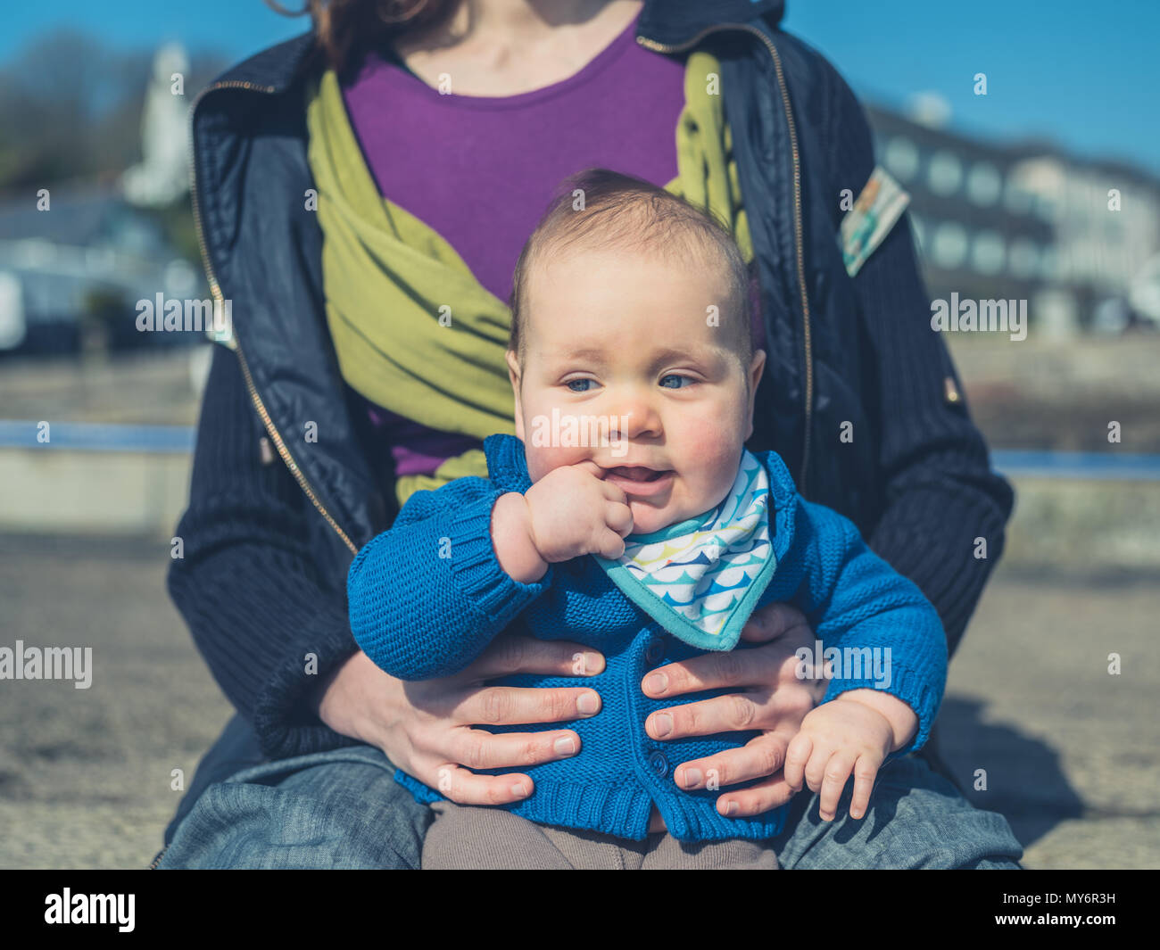 A young mother is relaxing with her baby outside Stock Photo - Alamy