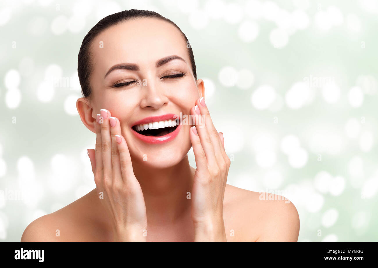 Young happy pretty woman with smooth and clean skin is posing against ...