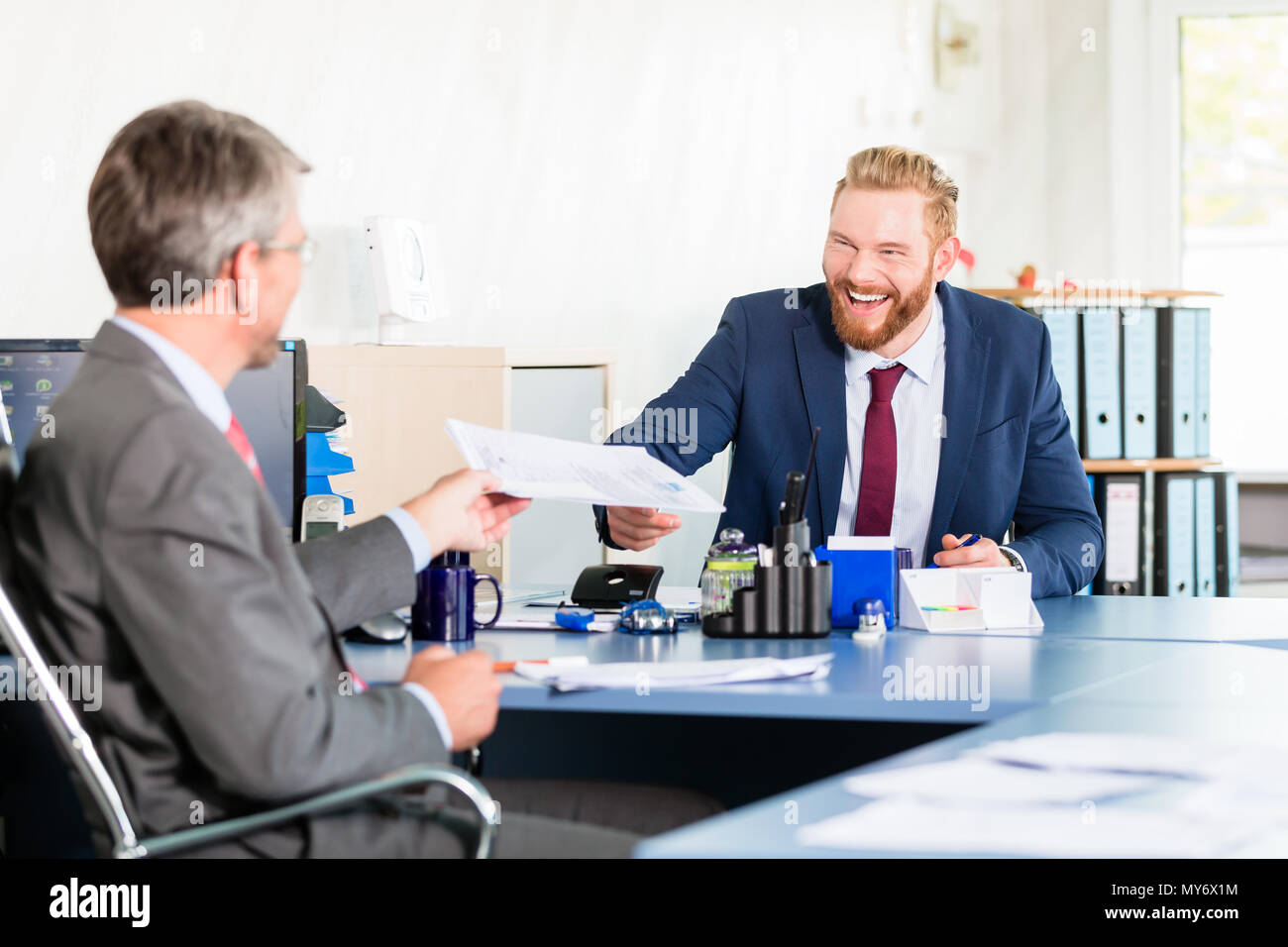 Manager signing documents at the office Stock Photo - Alamy
