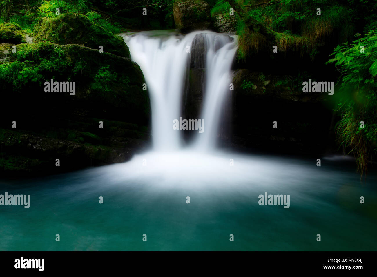Small waterfall of fresh water ends a well in the forest Stock Photo ...