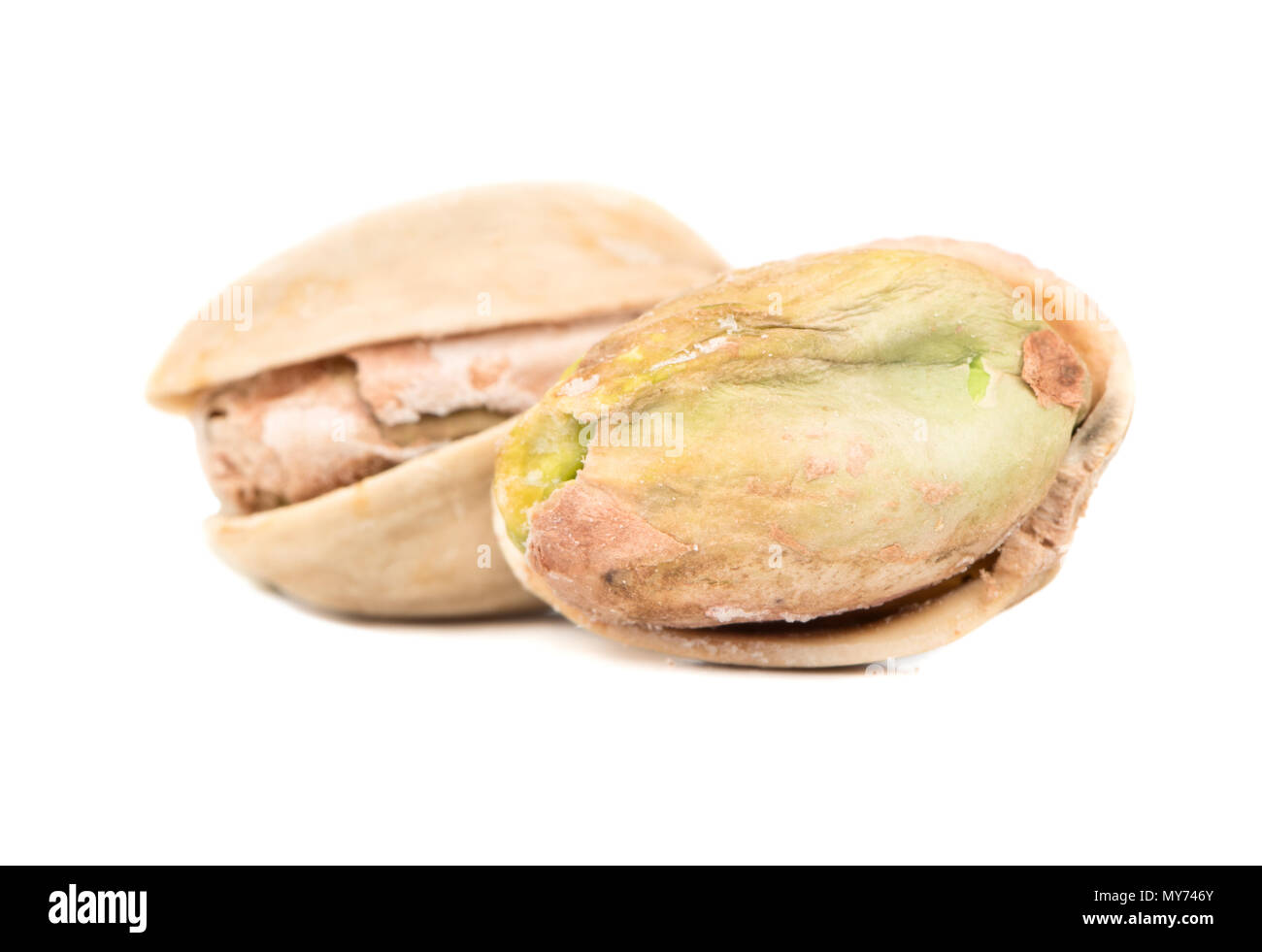 Delicious salted pistachio nuts in shell and without on a white ...