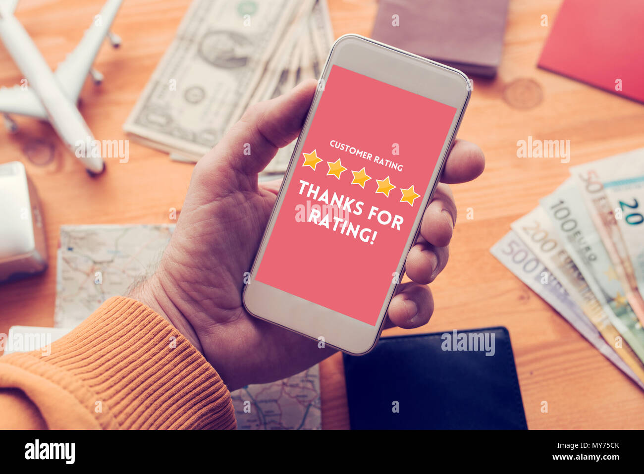 Thanks for rating message on smartphone screen in male hand. Customer ...