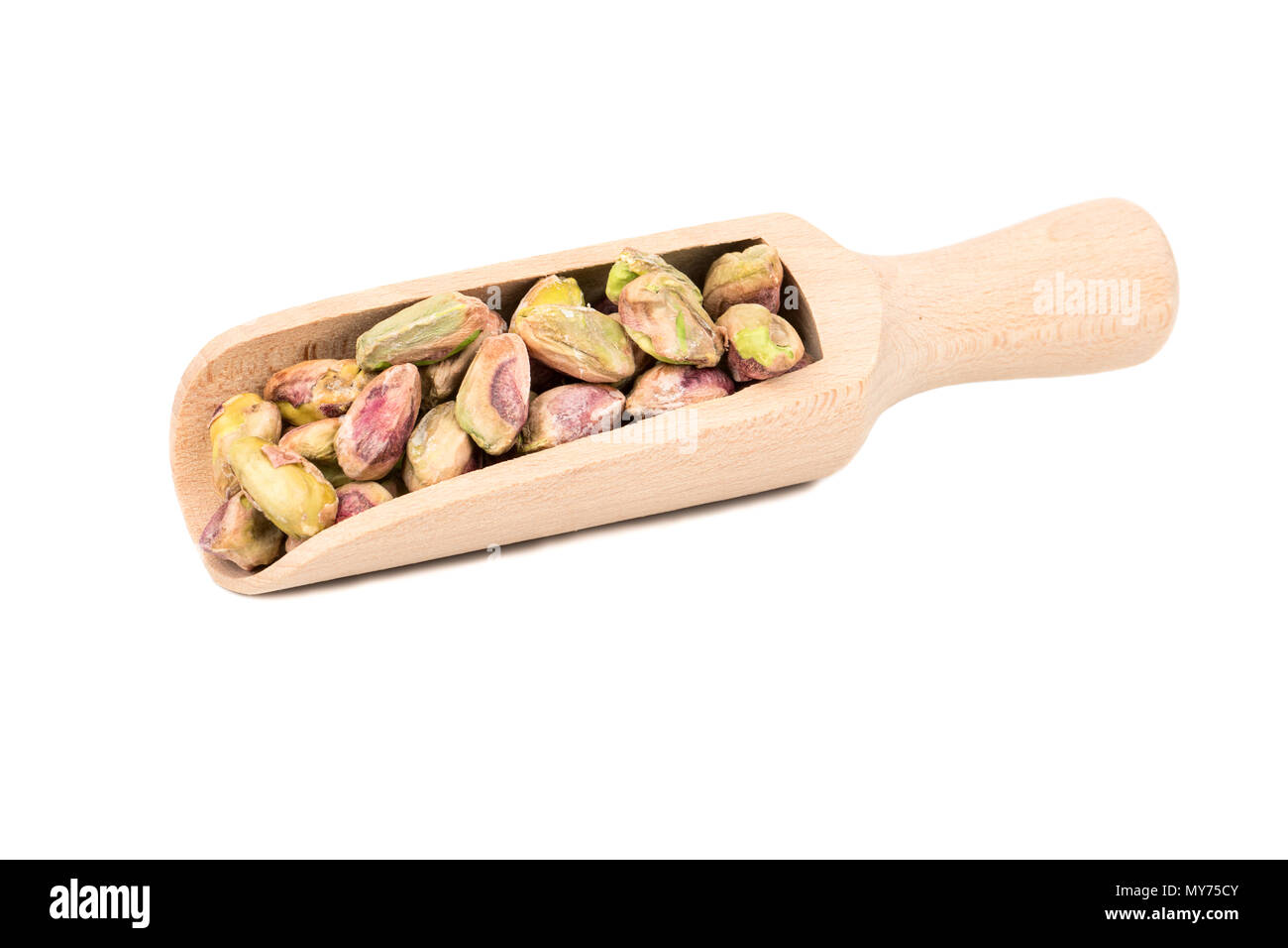 Pistachio nuts without a shell in a scoop on a white background Stock ...