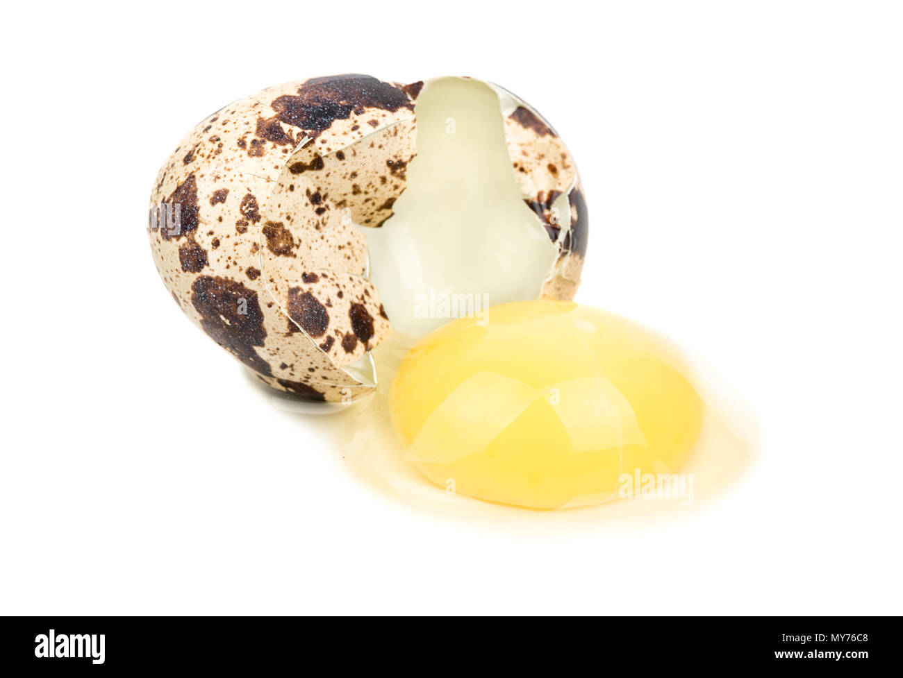 Broken raw quail egg on white background Stock Photo - Alamy