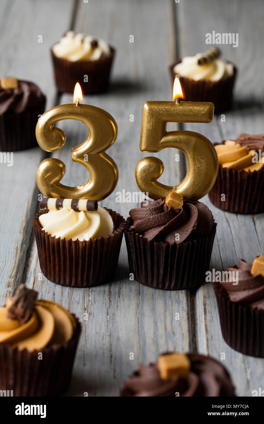 Number 35 celebration birthday cupcakes on a wooden background Stock ...