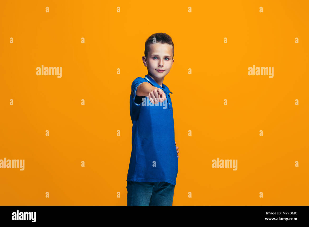 The happy teen boy pointing to you, half length closeup portrait on ...