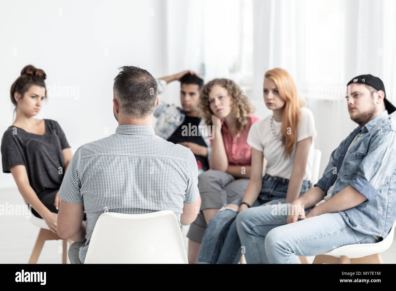 Group of young people talking to a psychologist in a rehab center Stock ...