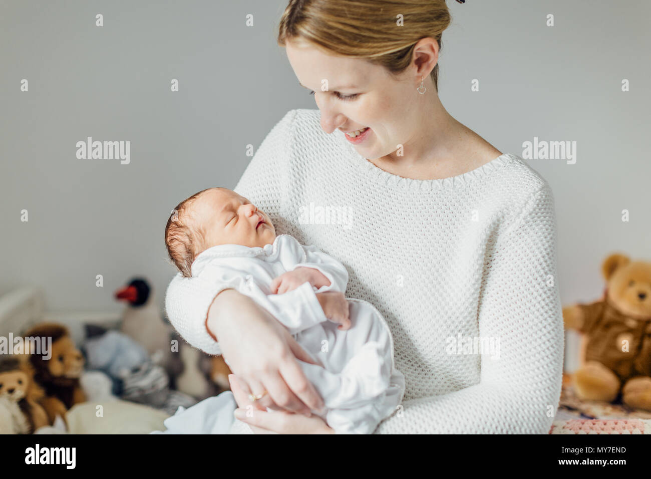 Mother holding newborn baby girl, smiling Stock Photo - Alamy