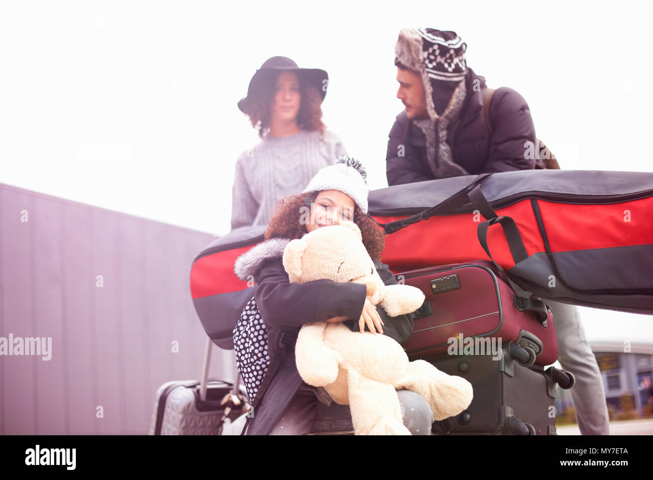 Girl with parents riding on luggage trolley Stock Photo - Alamy