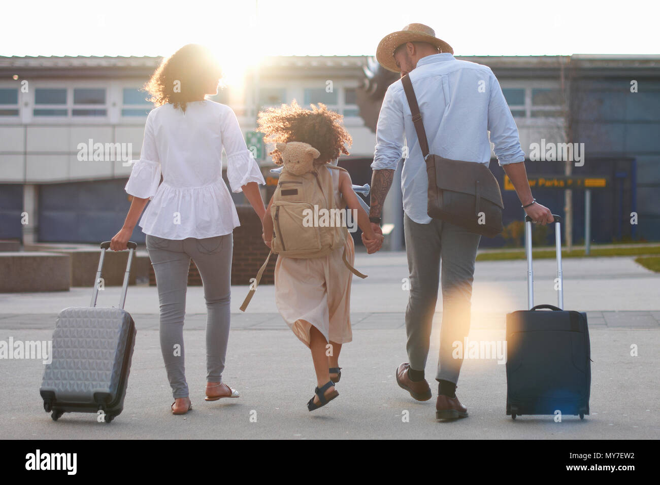 Family of three going on vacation Stock Photo - Alamy