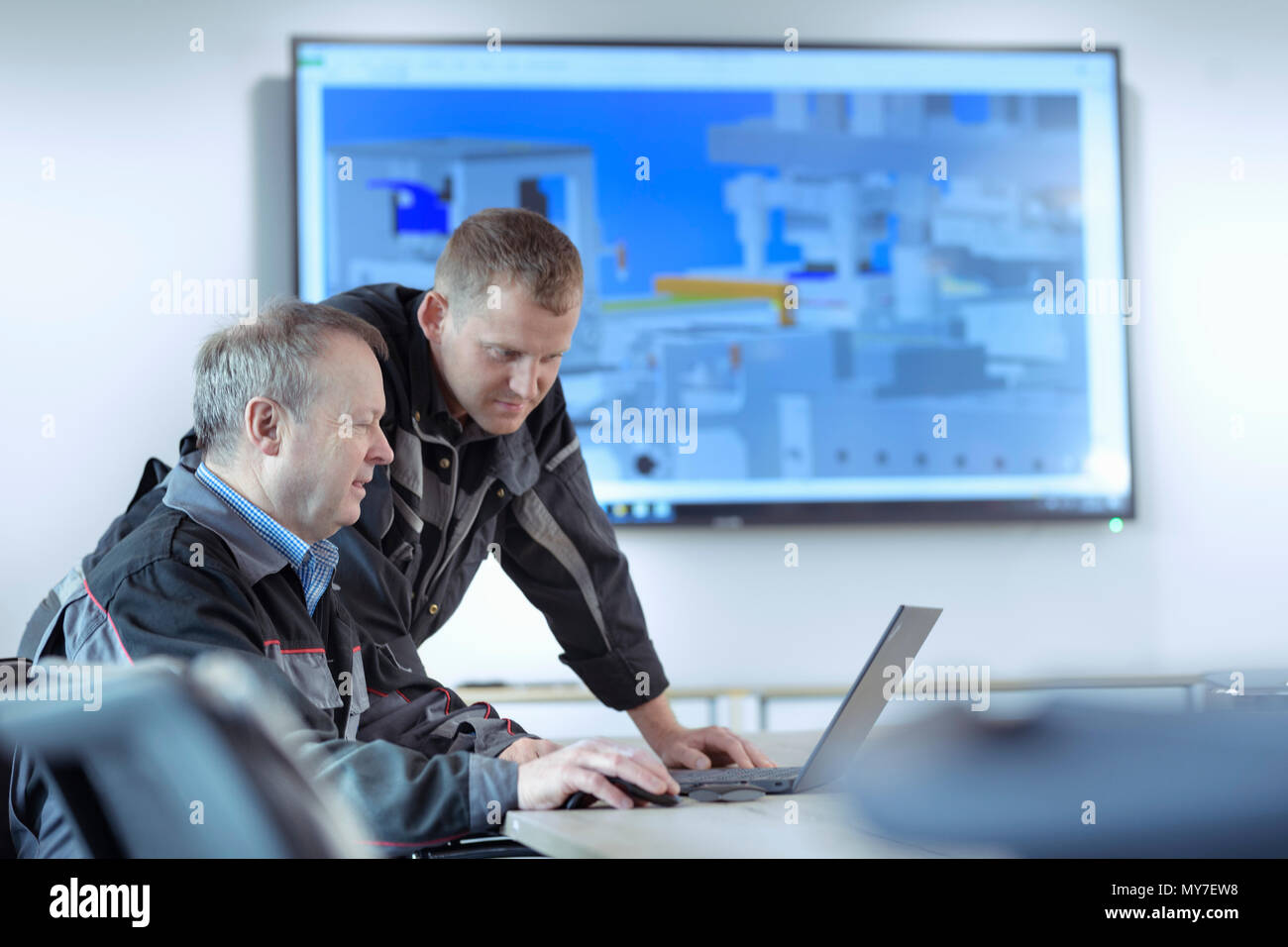 Two engineers looking at computer hi-res stock photography and images ...