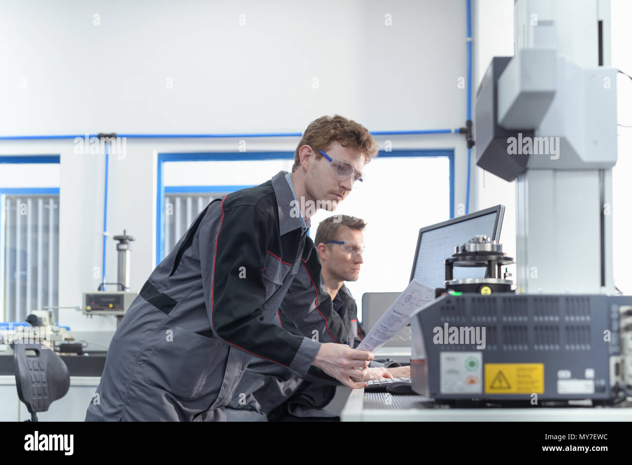 Two engineers looking at computer hi-res stock photography and images ...