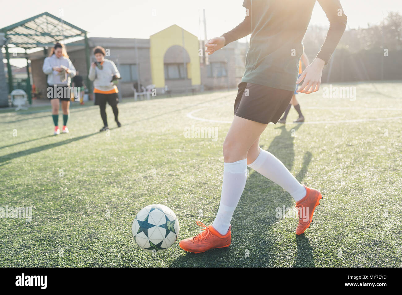 Football players playing on football pitch Stock Photo - Alamy