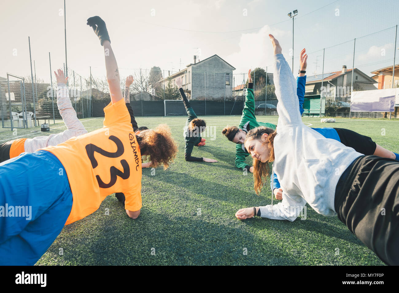 Football players in plank position on pitch Stock Photo - Alamy