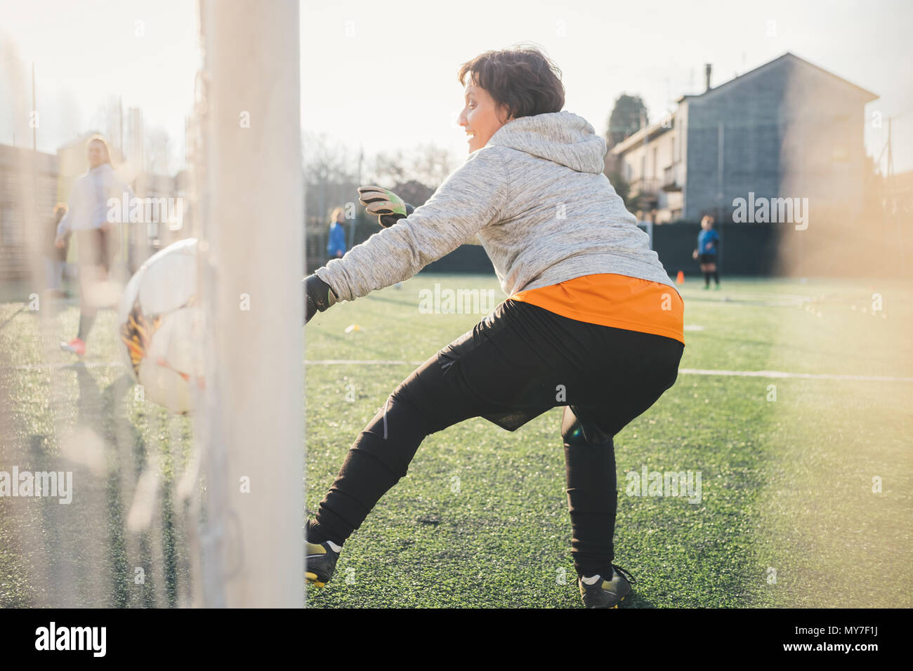 Goalkeeper defending goal Stock Photo - Alamy