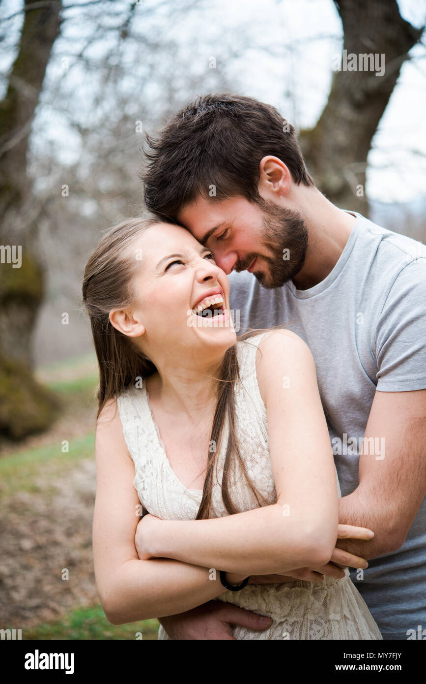 Couple hugging from behind laughing hi-res stock photography and images ...