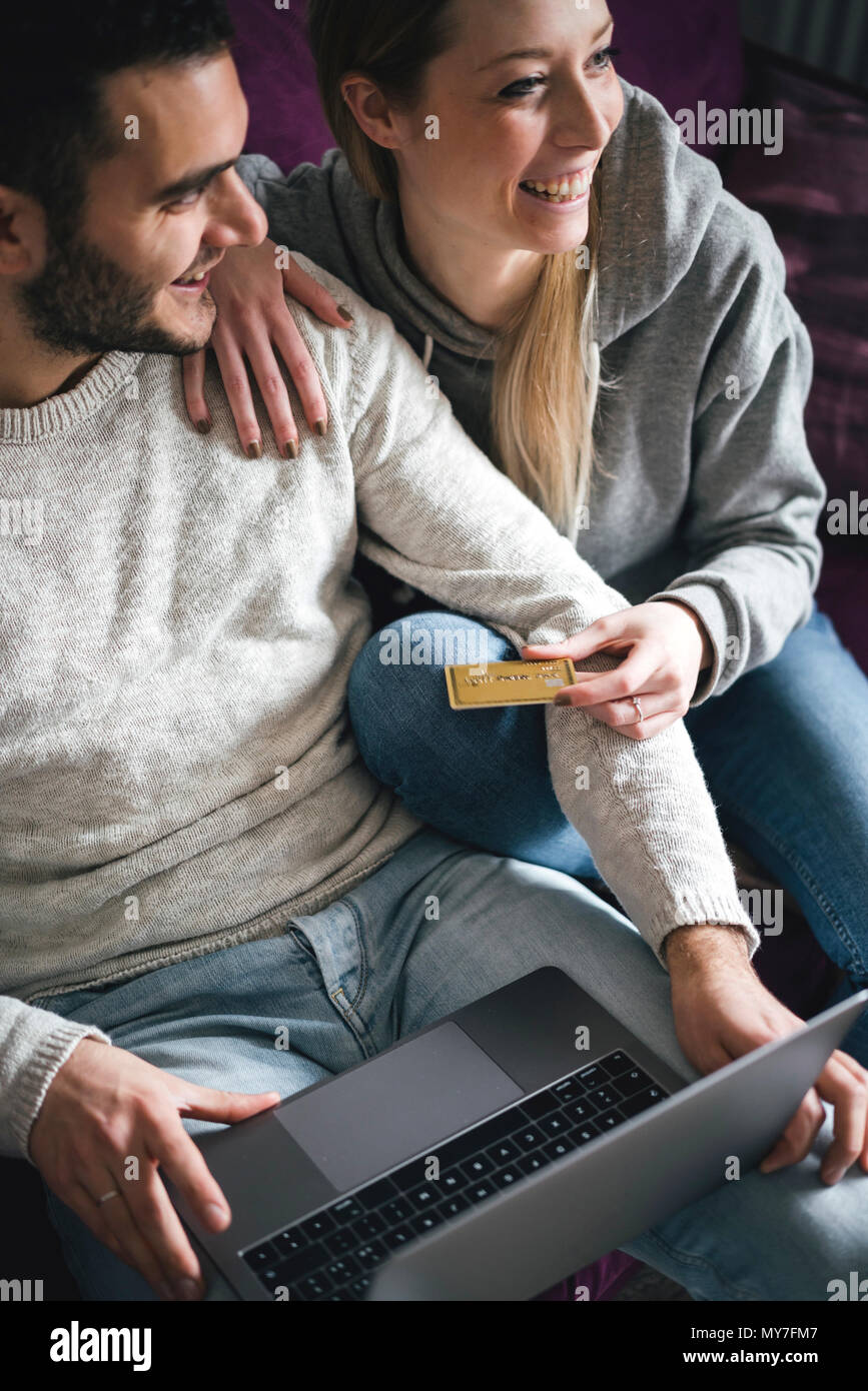 Couple using credit card laptop hi-res stock photography and images - Alamy