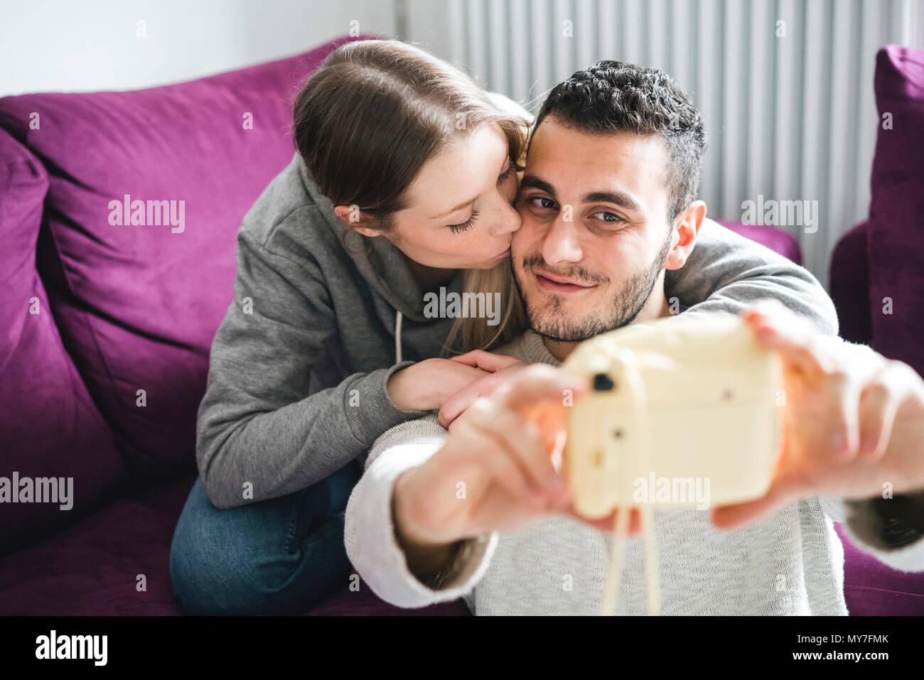 Couple using instant camera to take selfie Stock Photo - Alamy