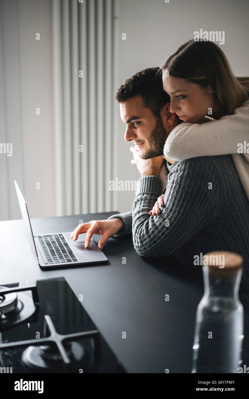 Couple using laptop together Stock Photo - Alamy