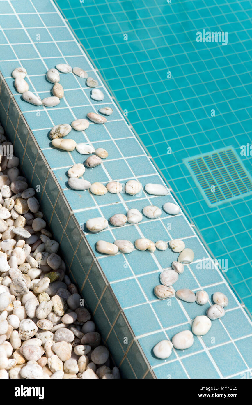 The inscription " swim " is laid out by pebble on a pool side Stock ...