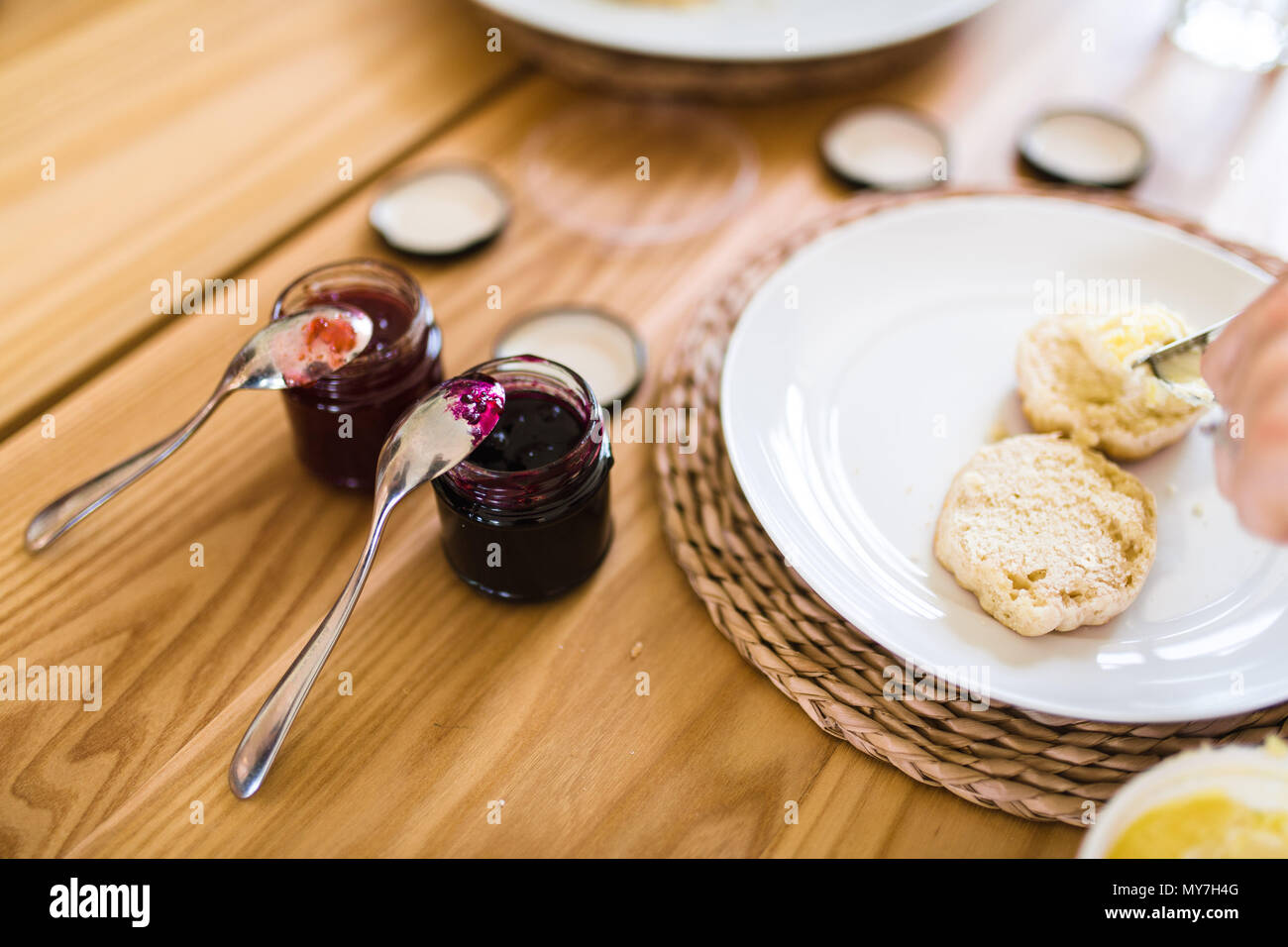 Spreading clotted cream on scone hi-res stock photography and images ...
