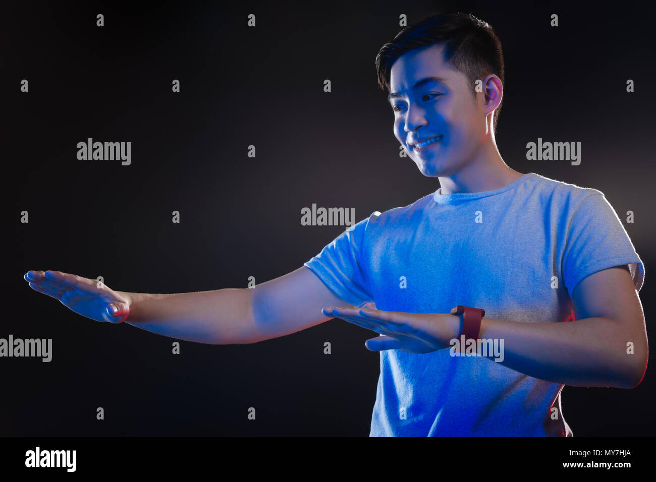 Happy delighted man enjoying new technology Stock Photo - Alamy