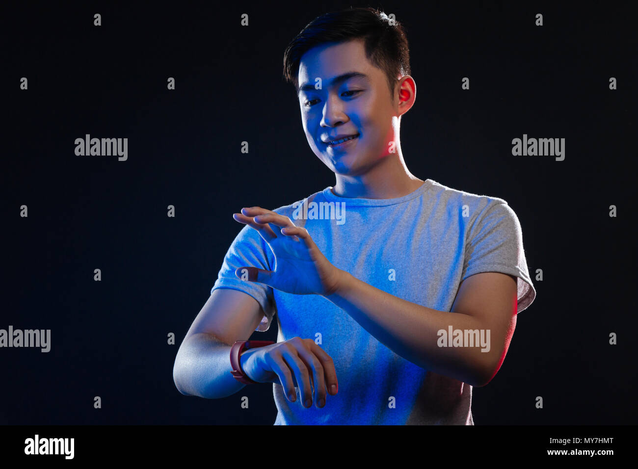 Happy cheerful man having a smartwatch Stock Photo - Alamy
