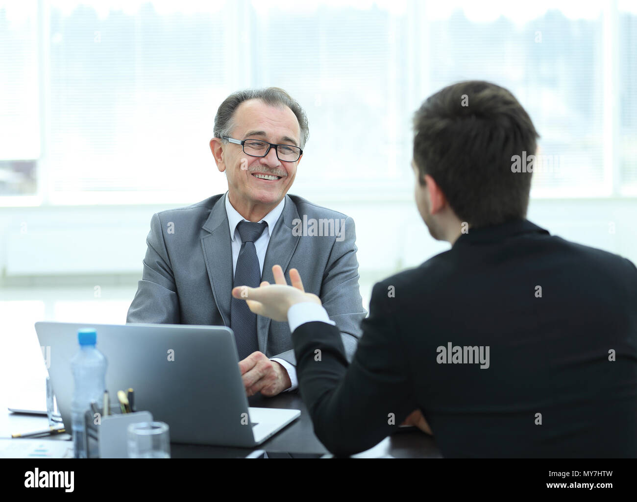 close up.business people talking at a Desk Stock Photo - Alamy