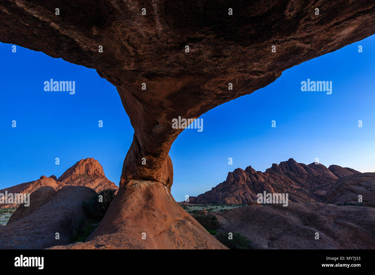 Rock arch, in the back Spitzkoppe and Pontok Mountains, Erongo region ...