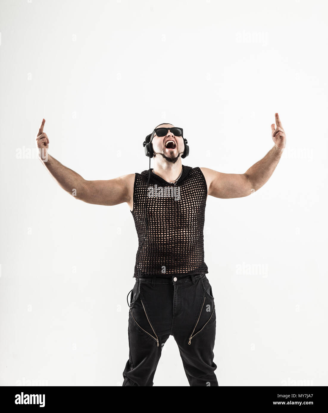 emotional and charismatic DJ - rapper with headphones on a light Stock ...