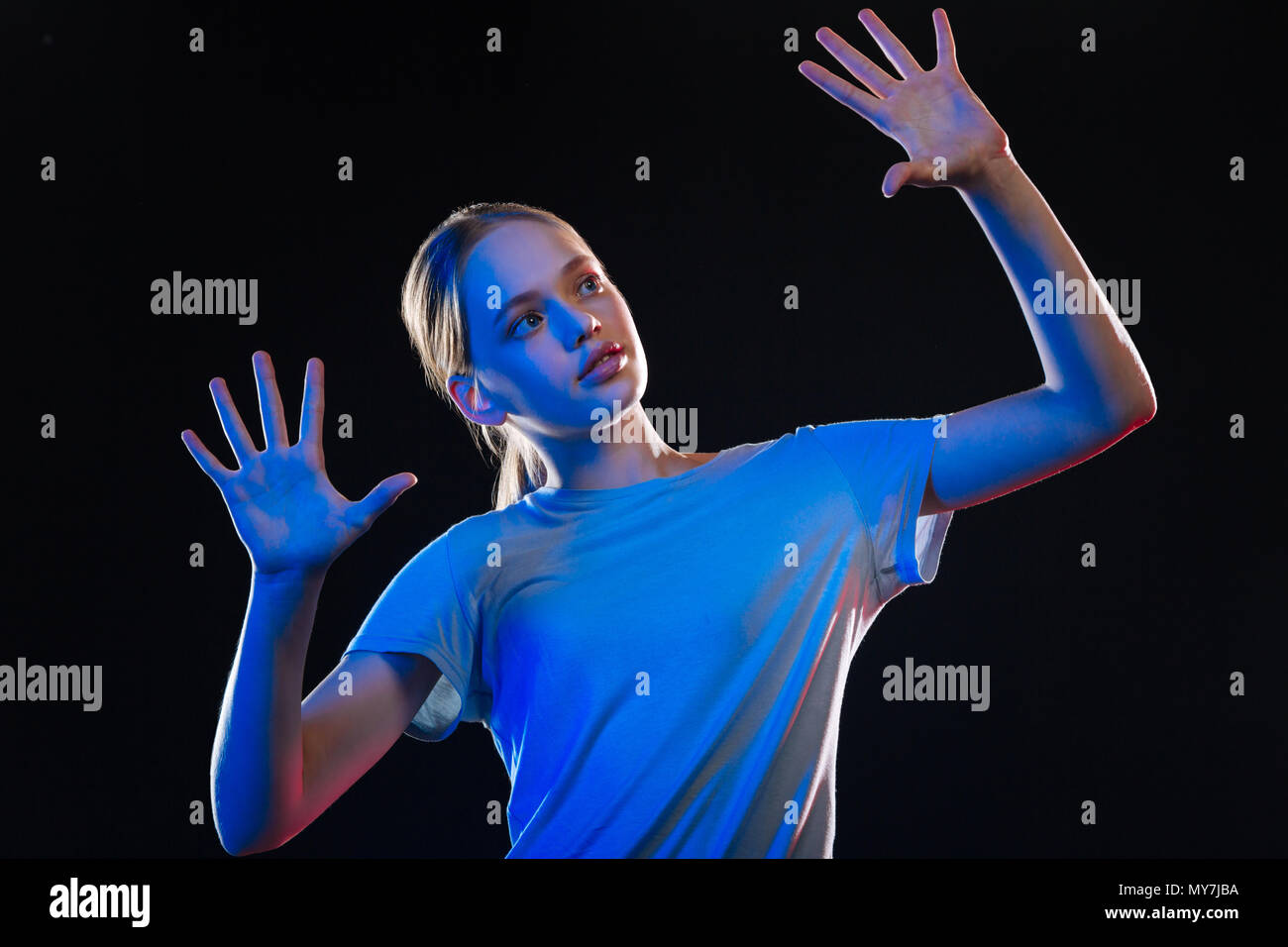 Pretty blonde woman standing in front of the sensory screen Stock Photo ...