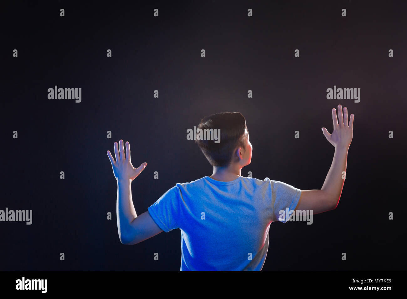 Nice young man looking at his hands Stock Photo - Alamy