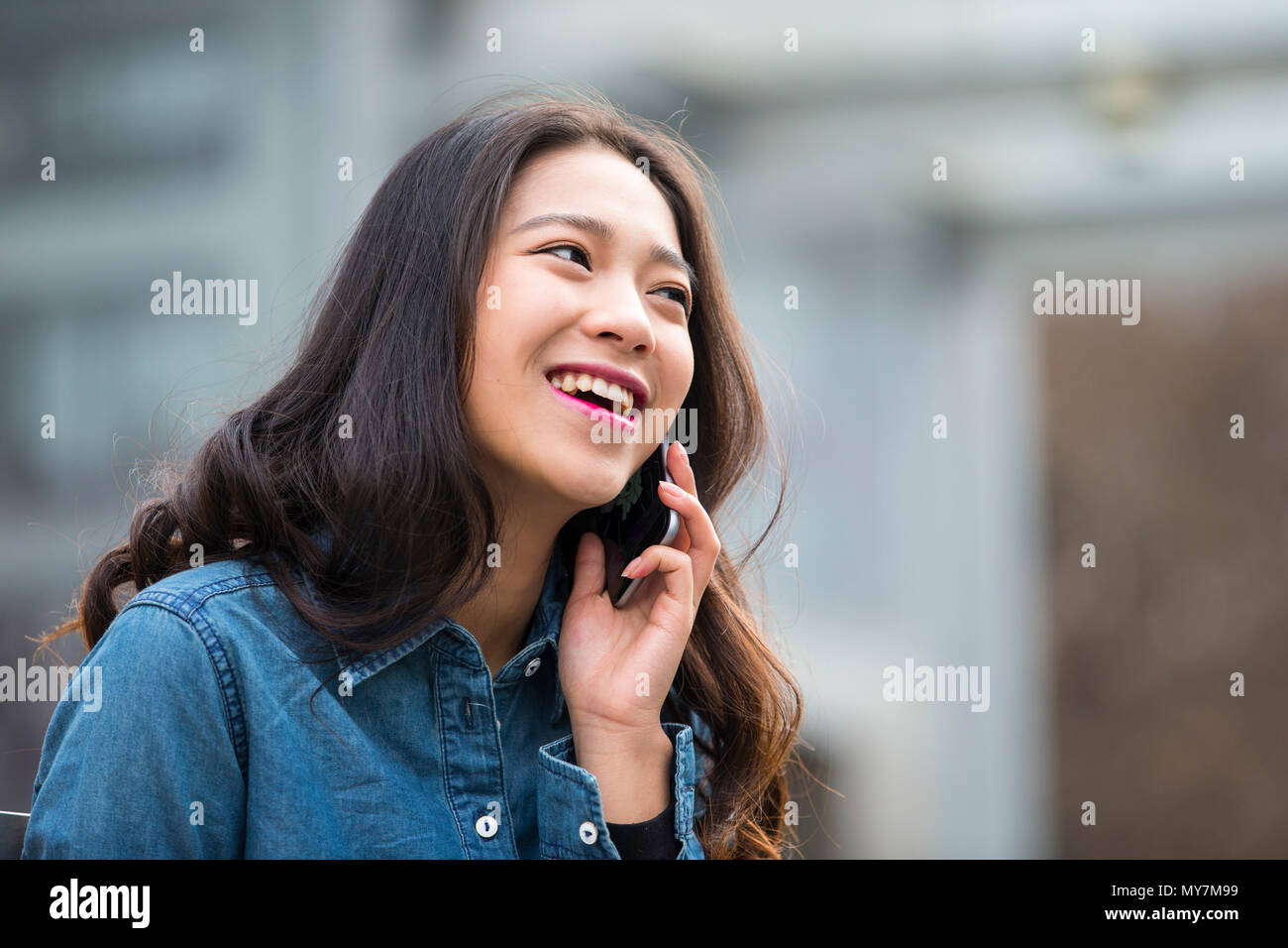 Picture of One beautiful young Chinese woman using mobile phone outdoor ...