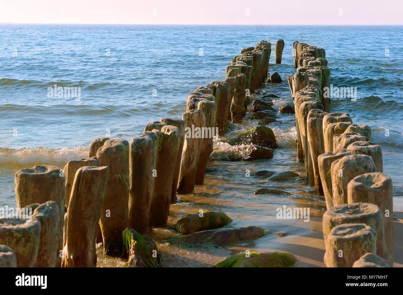a breakwater made of wood, the groynes in the sea, sea waves protection ...