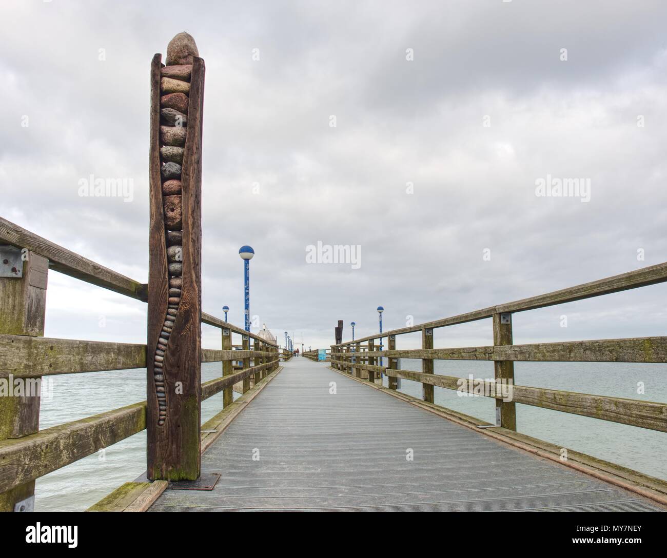 Wooden bridge pier leading to summer sea with blue sky. Island famous ...
